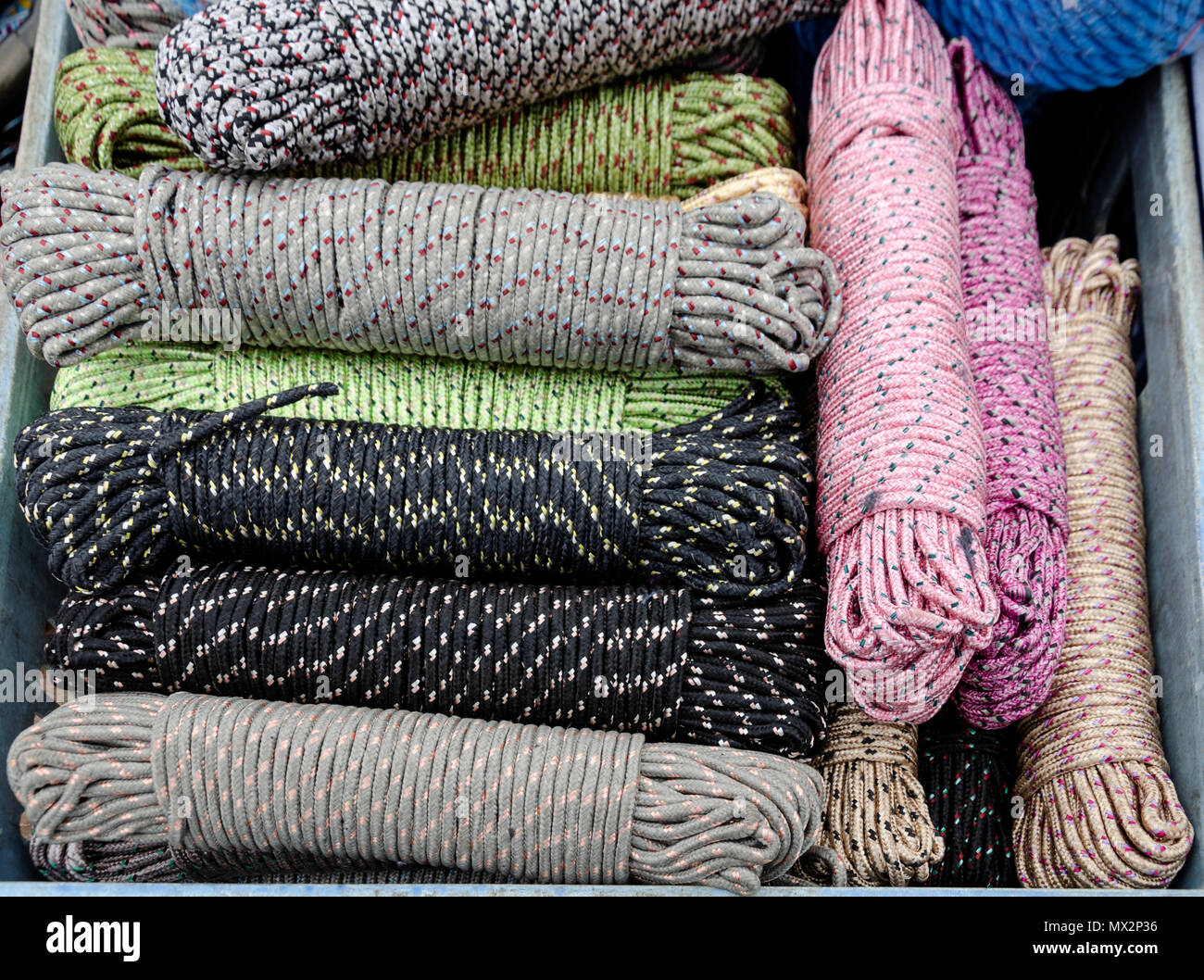 Bundles of black and pastel coloured nylon rope Stock Photo - Alamy