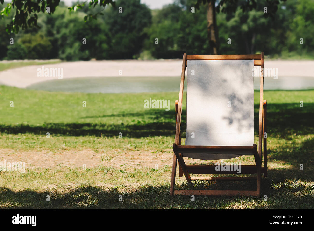 Chair under tree hi-res stock photography and images - Alamy