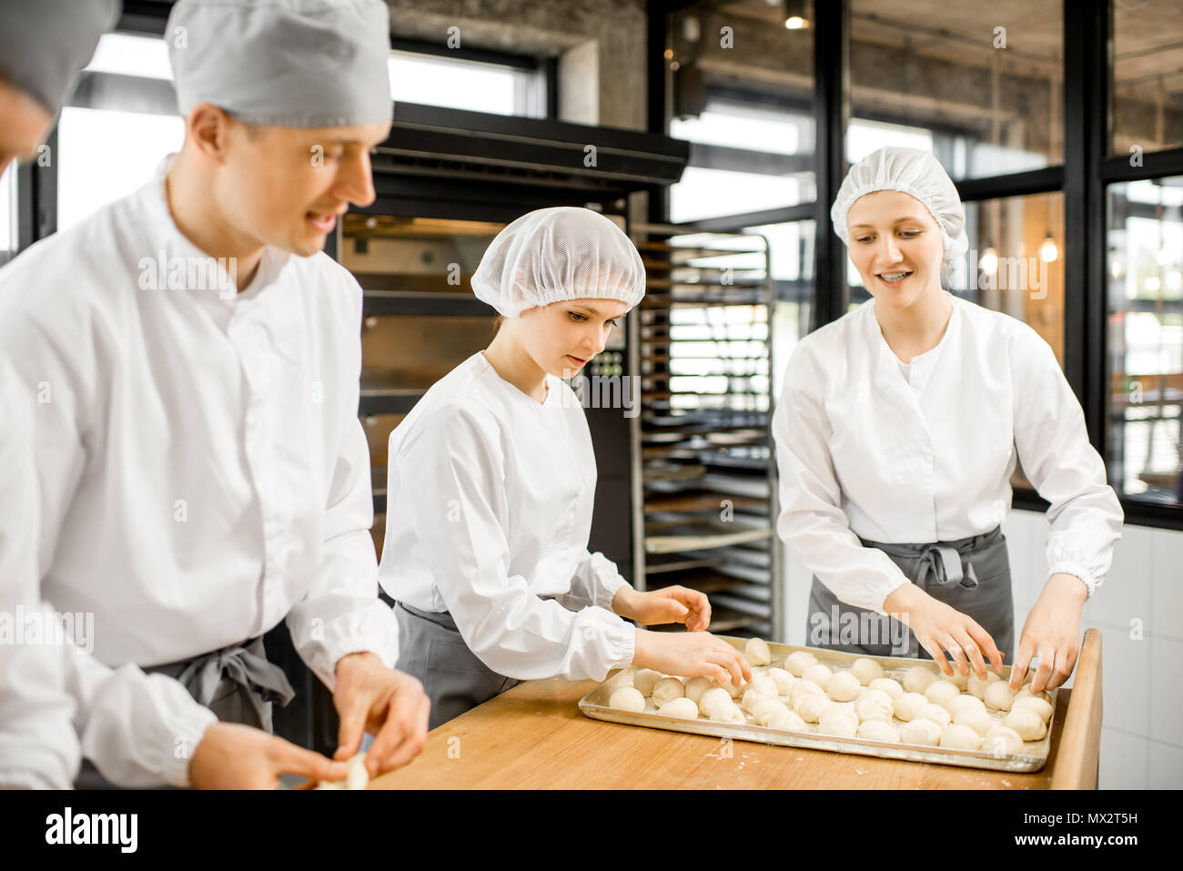 Bakers forming dough for baking at the manufacturing Stock Photo - Alamy