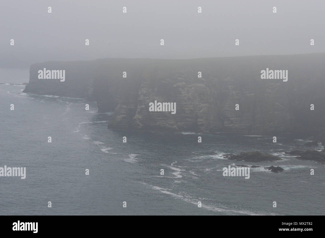 Landscape of cliffs covered in fog Stock Photo - Alamy