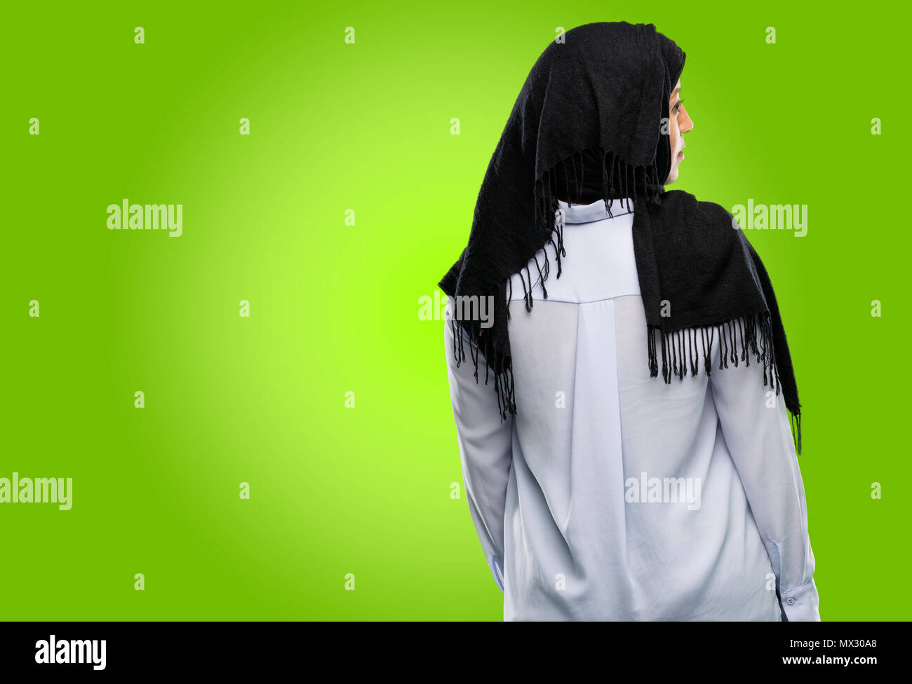 Young arab woman wearing hijab backside, rear view Stock Photo - Alamy