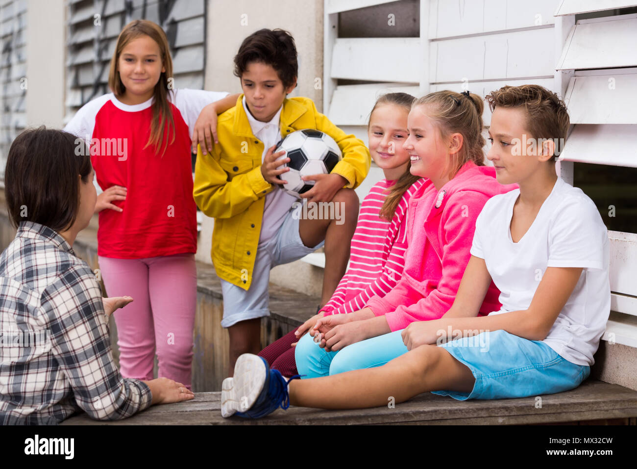 Small children talking on playground hi-res stock photography and ...