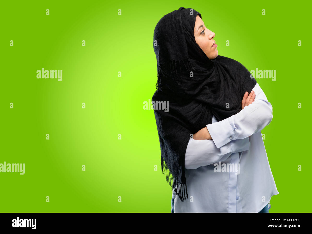 Young arab woman wearing hijab with crossed arms confident and happy ...