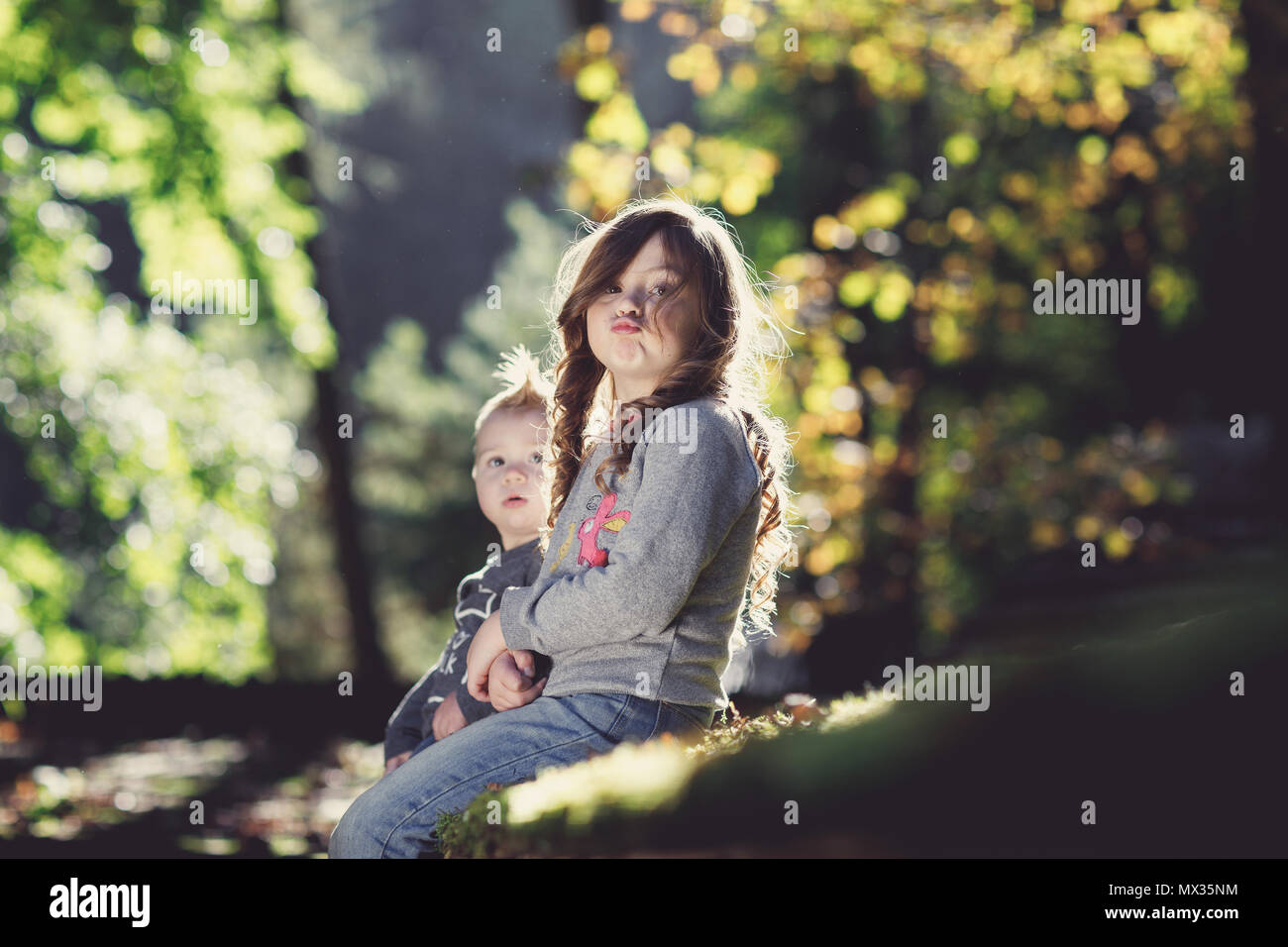 Happy children playing on green grass in spring park Stock Photo - Alamy