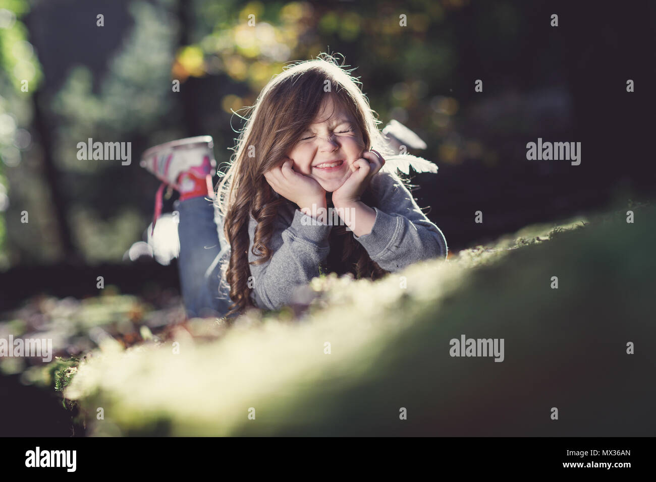 Happy children playing on green grass in spring park Stock Photo - Alamy