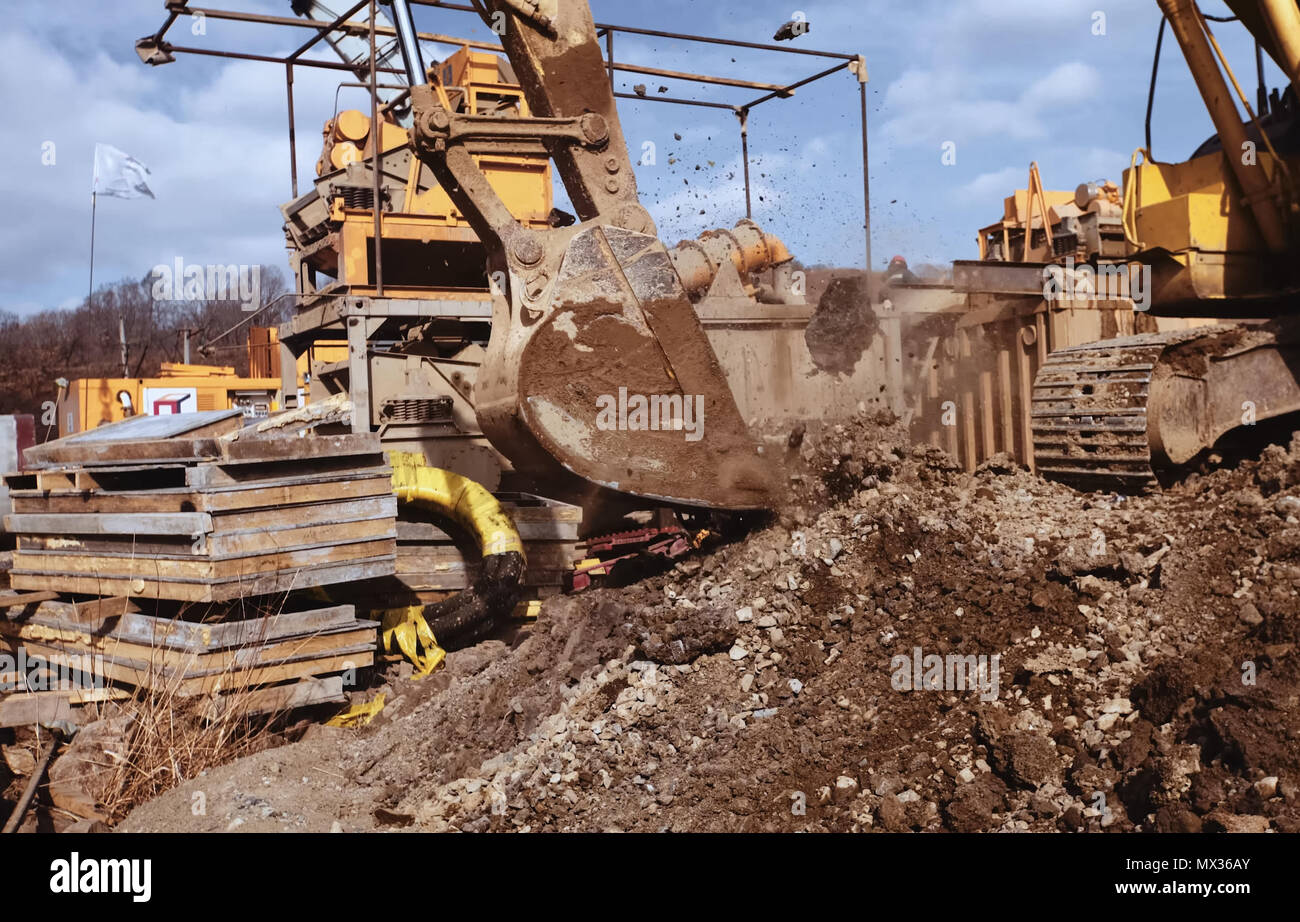 Bulldozer bucket. A bulldozer digs a hole Stock Photo - Alamy