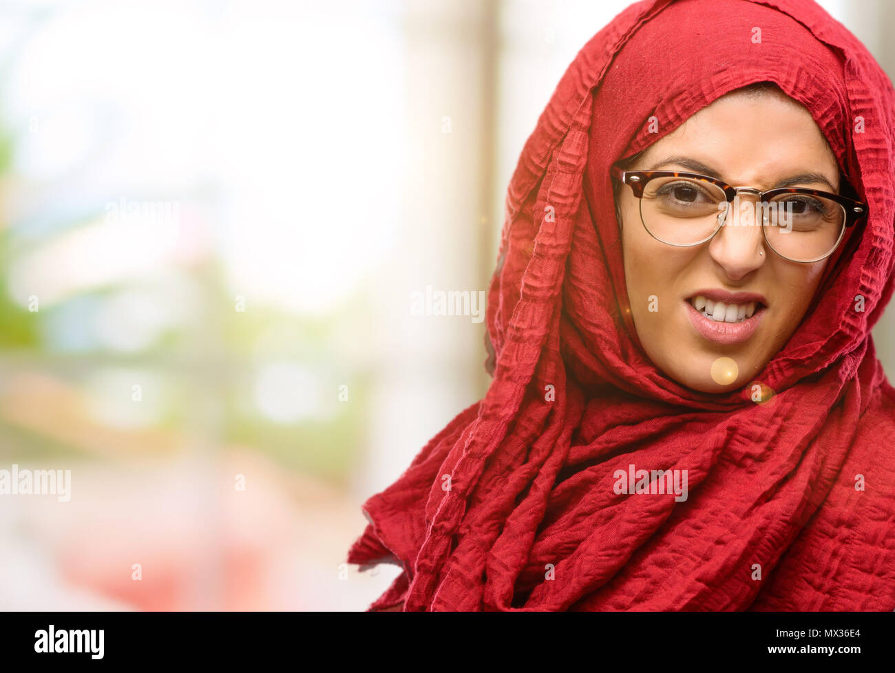 Young arab woman wearing hijab angry and stressful frowns face in ...
