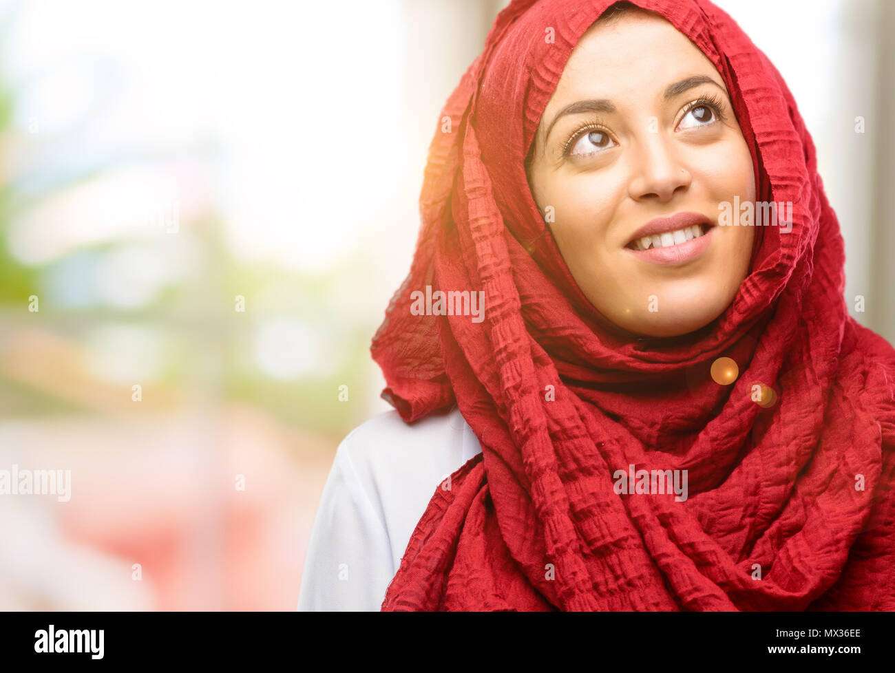 Young arab woman wearing hijab confident and happy with a big natural ...