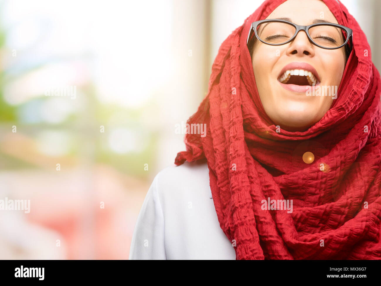 Young arab woman wearing hijab confident and happy with a big natural ...