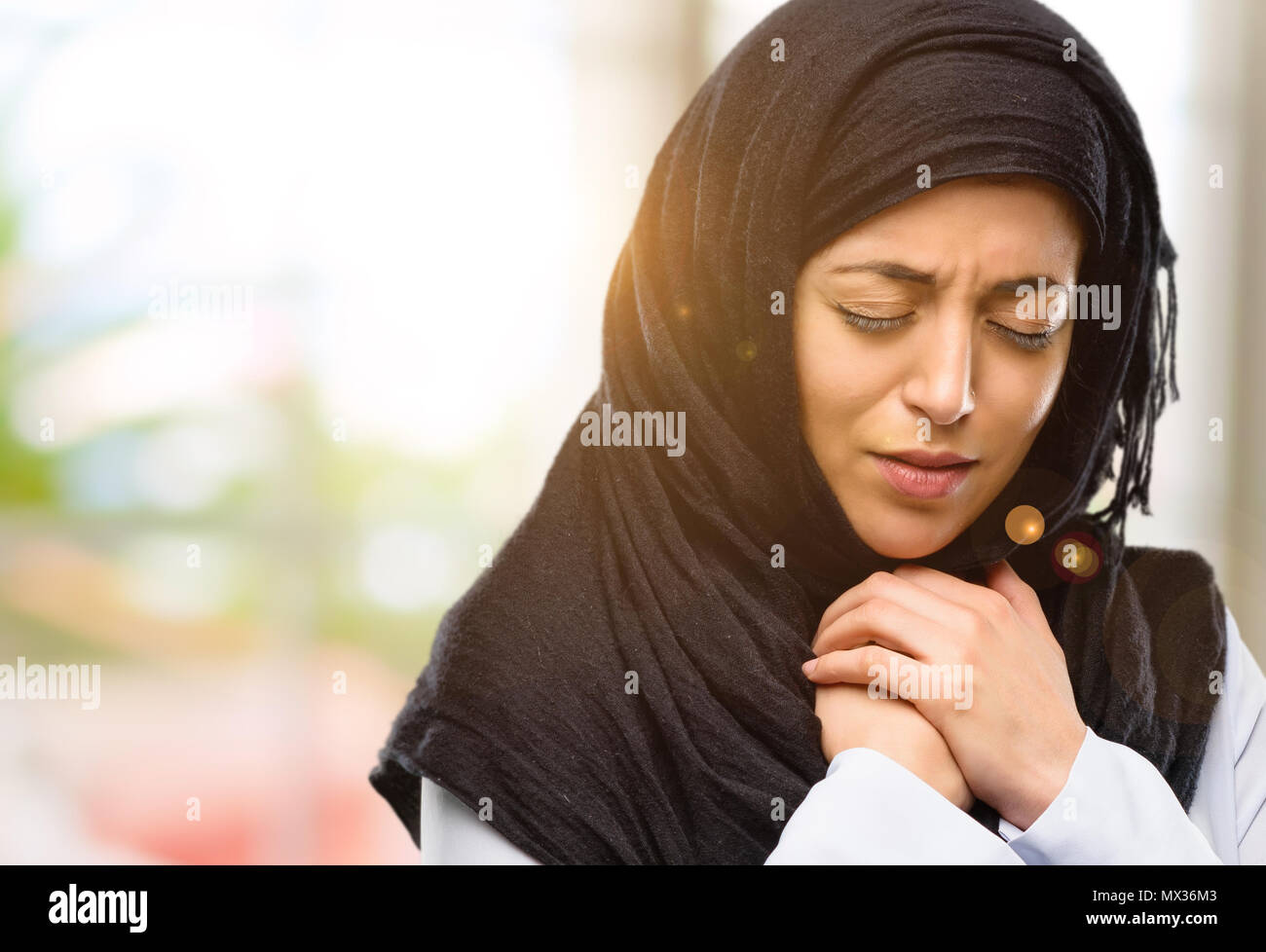 Young arab woman wearing hijab crying depressed full of sadness ...