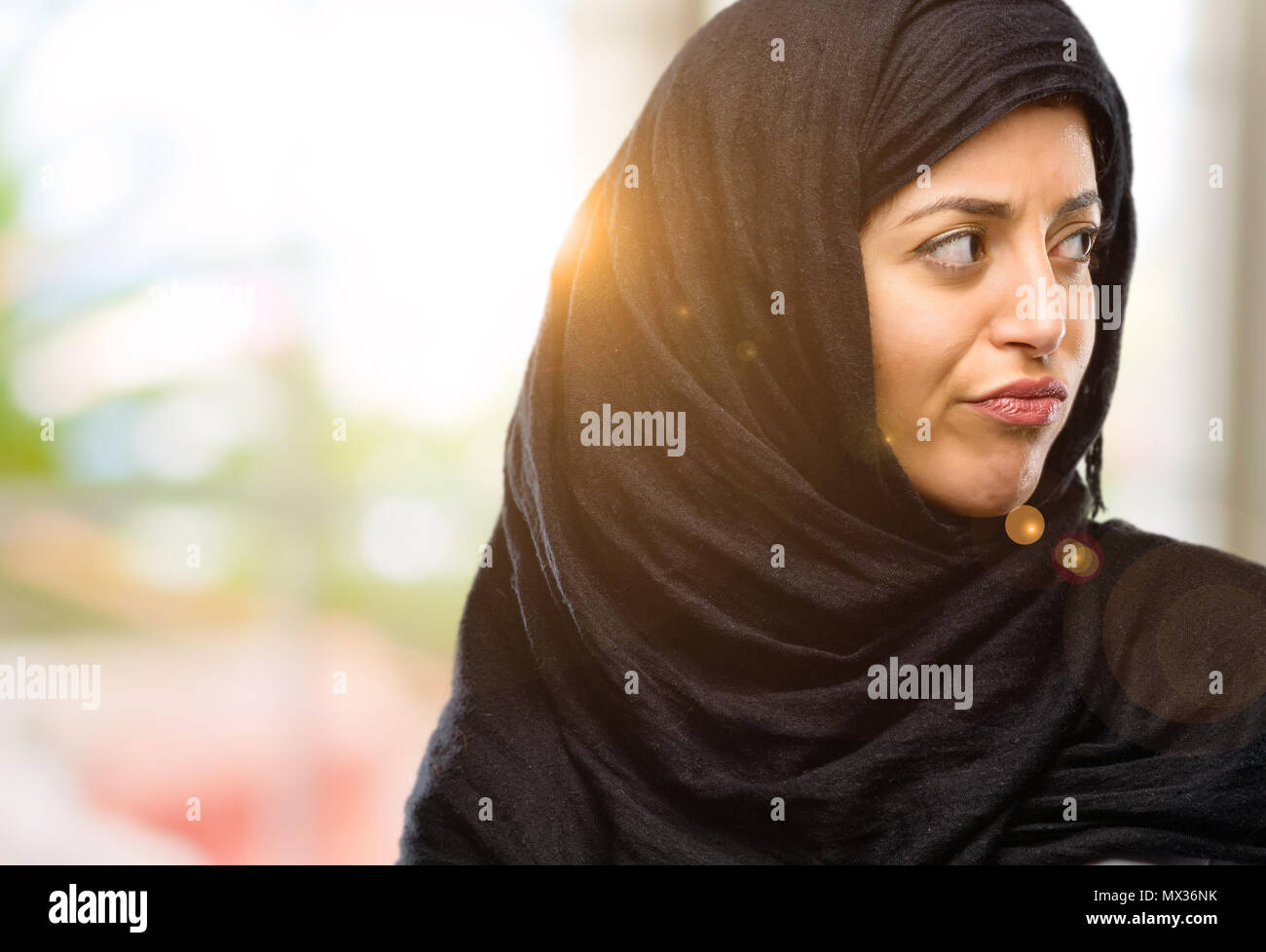 Young arab woman wearing hijab irritated and angry expressing negative ...