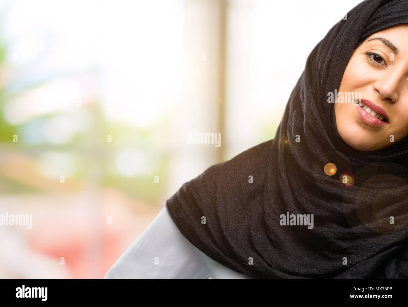 Young arab woman wearing hijab confident and happy with a big natural ...