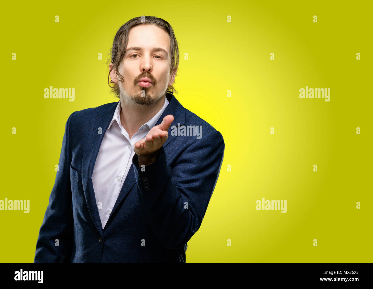 Handsome young man expressing love, blows kiss at camera, flirting ...