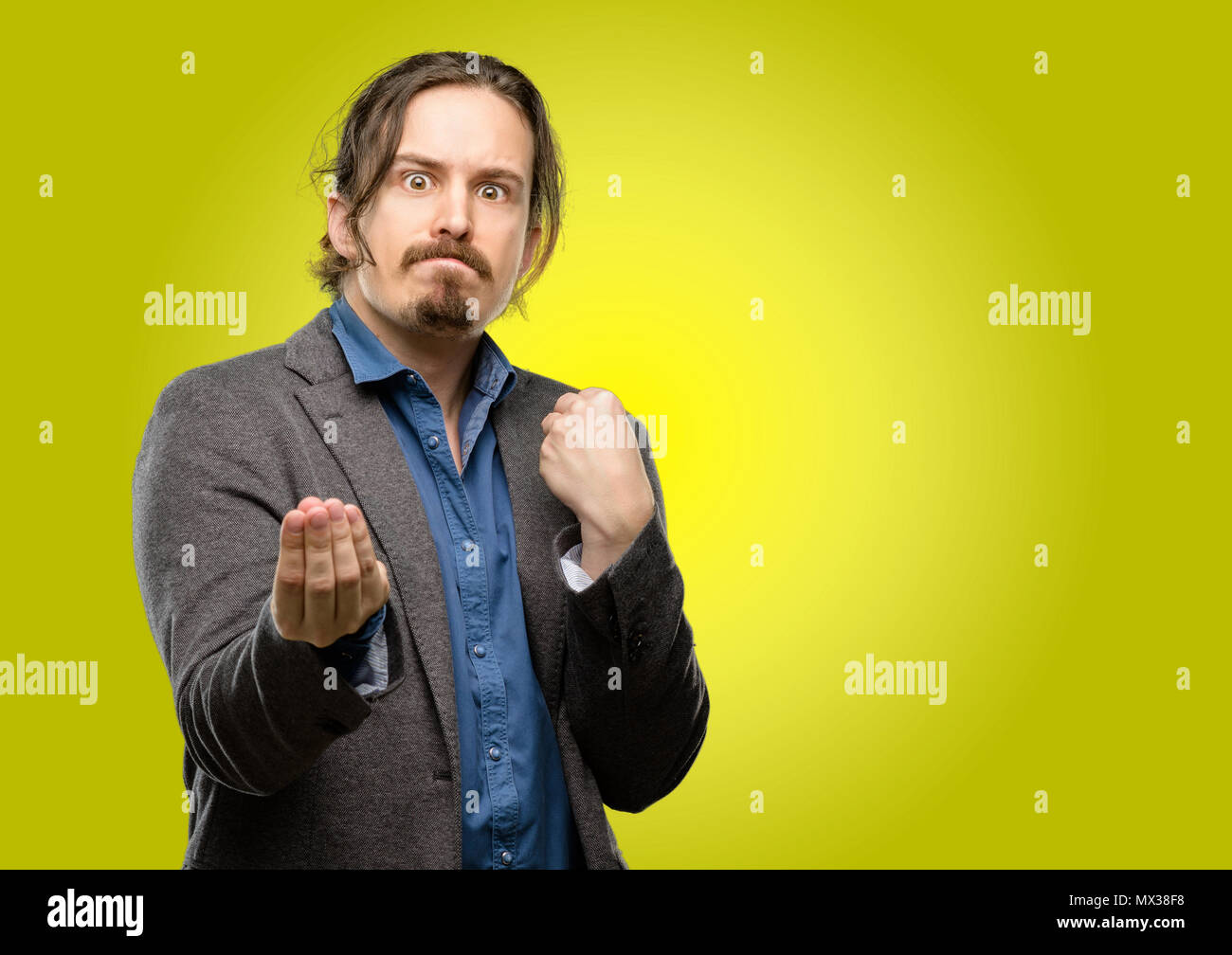 Handsome young man angry gesturing typical italian gesture with hand ...