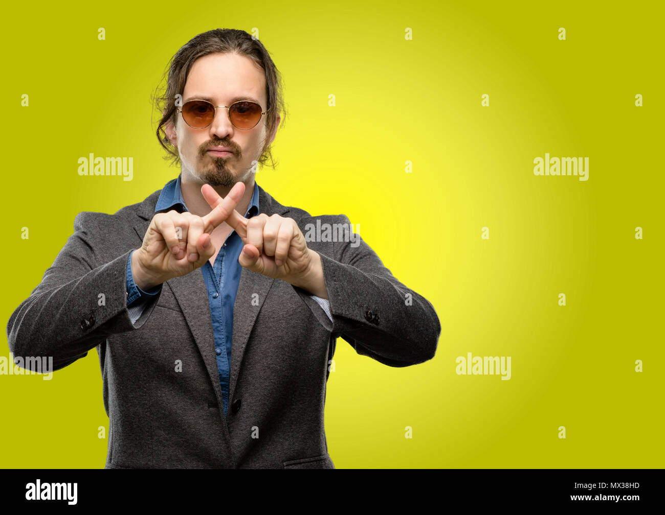 Handsome young man annoyed with bad attitude making stop sign with hand ...