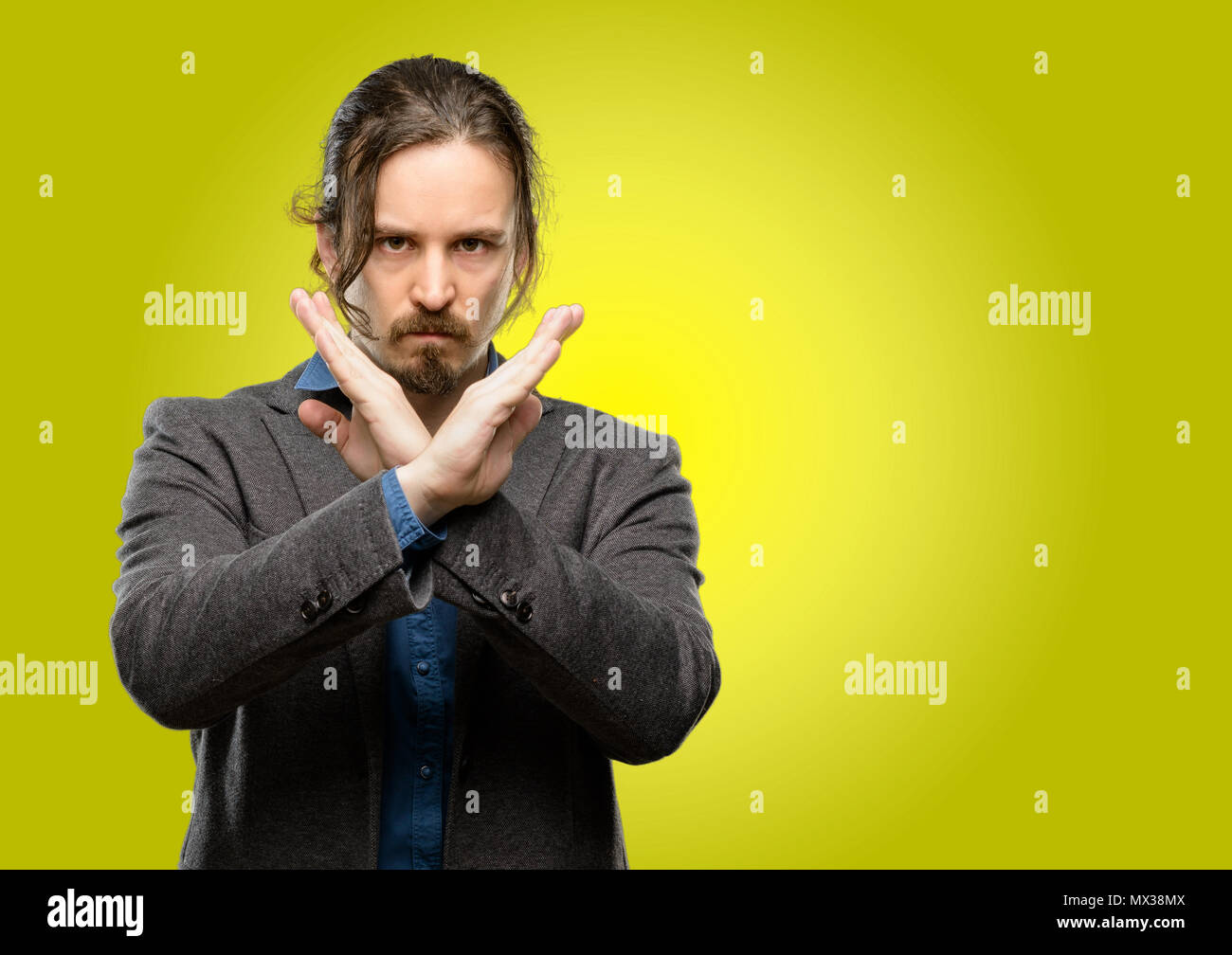 Handsome young man annoyed with bad attitude making stop sign crossing ...