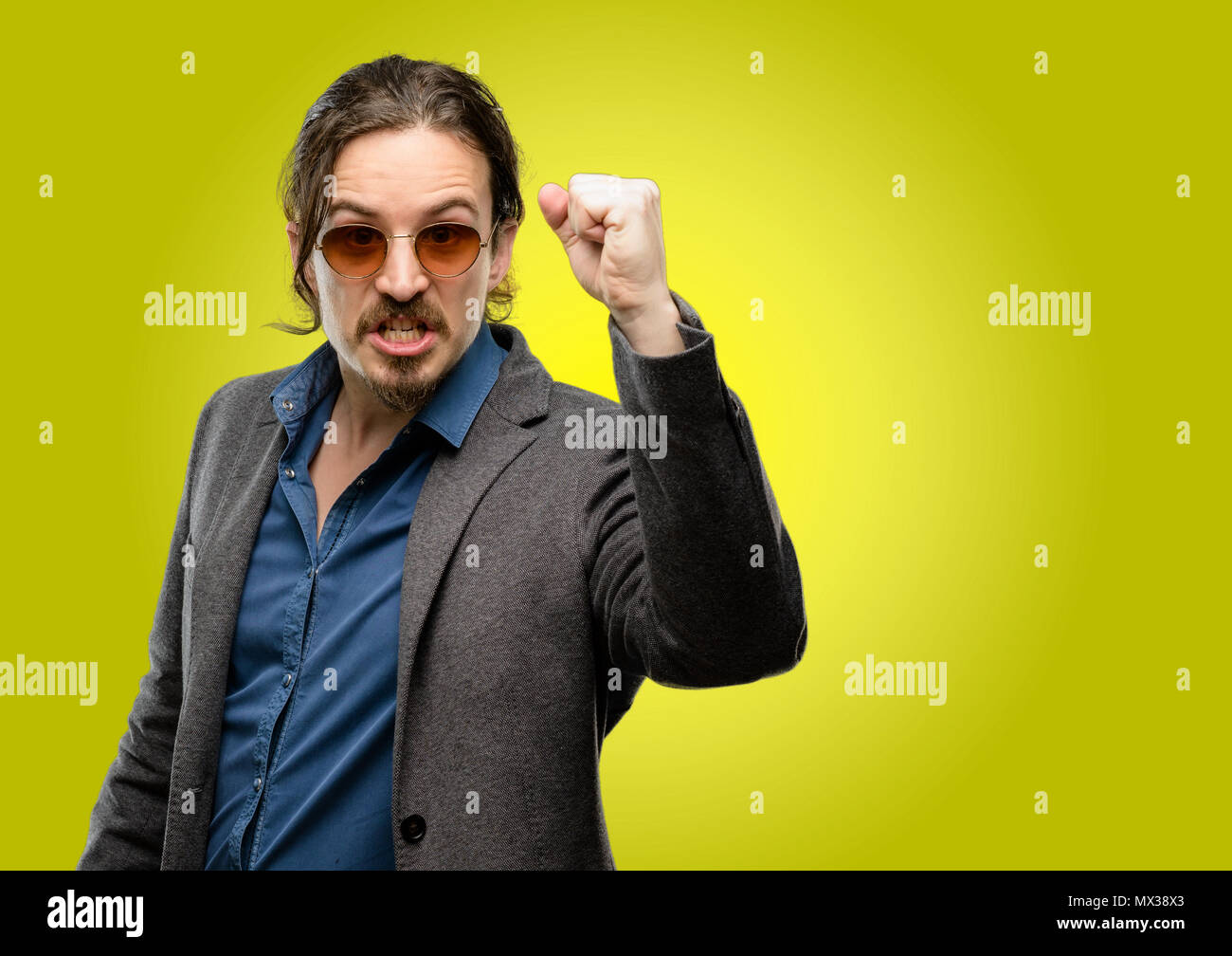 Handsome young man irritated and angry expressing negative emotion ...