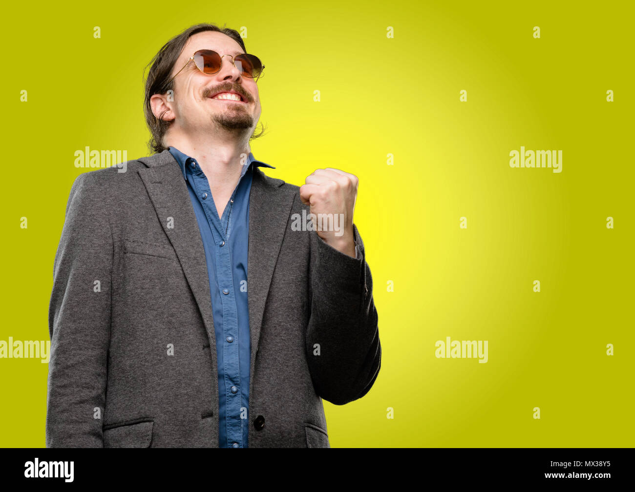 Handsome young man happy and excited expressing winning gesture ...