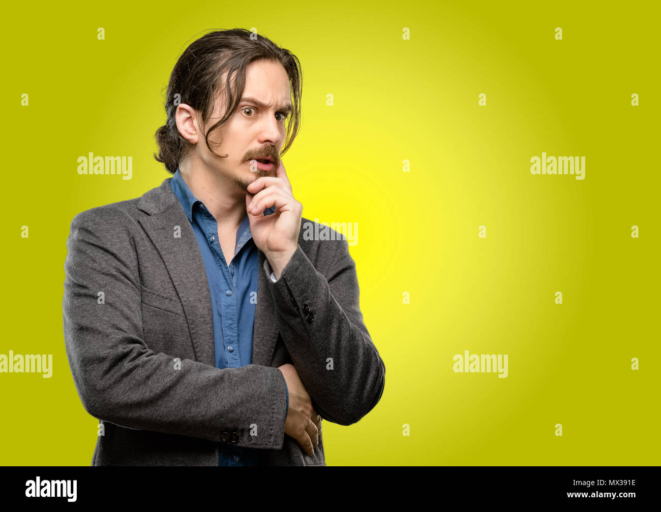 Handsome young man scared in shock, expressing panic and fear Stock ...