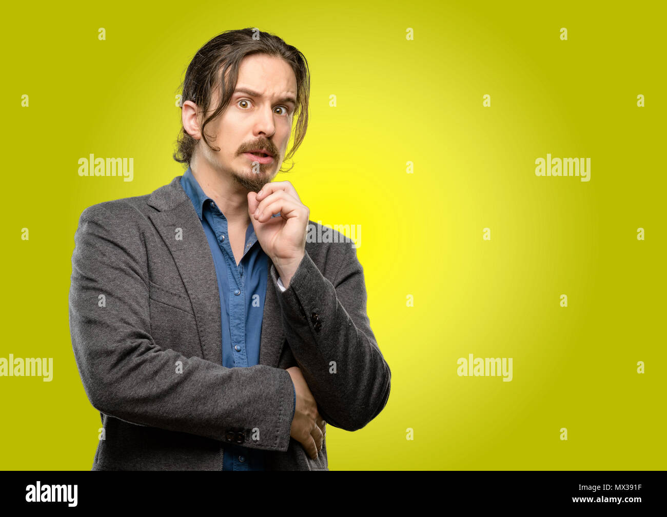 Handsome young man scared in shock, expressing panic and fear Stock ...
