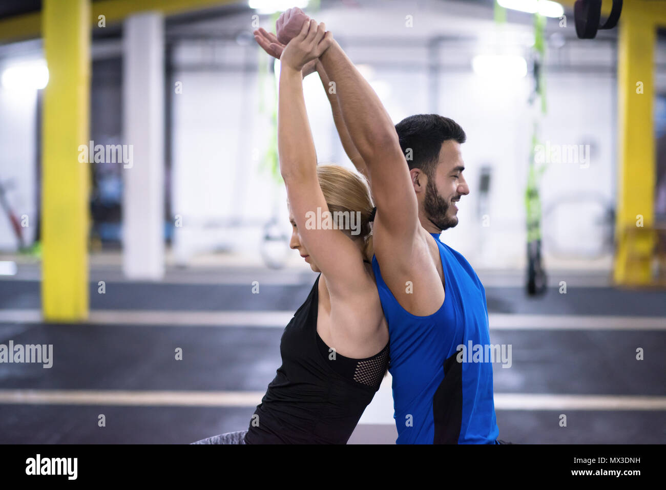 young couple athletes working out their arms using boxes at cross ...