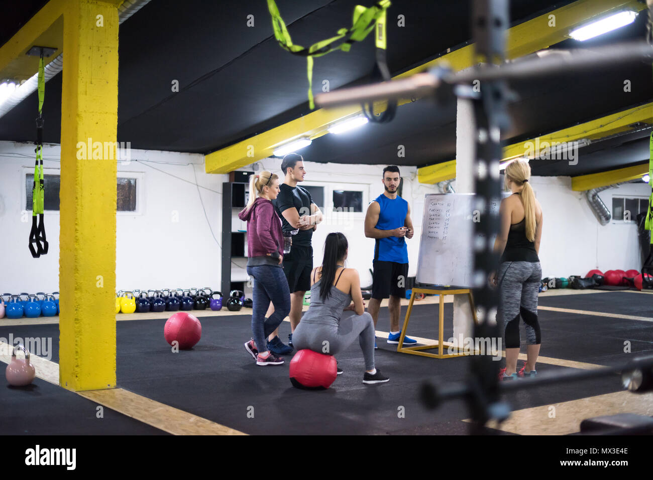 Training course.group of young athletes getting instructions from ...