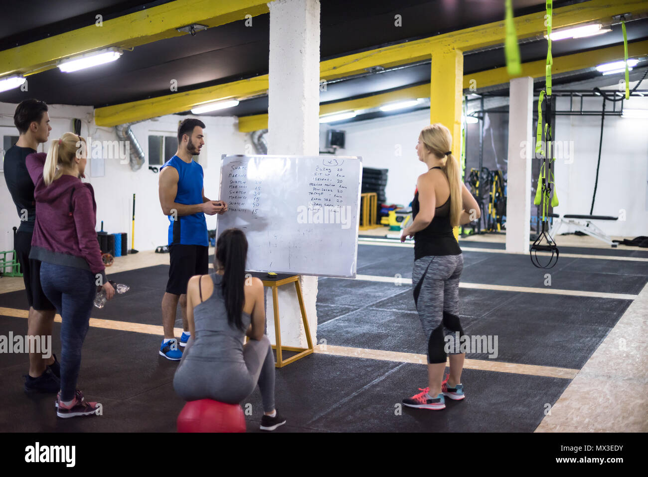 Training course.group of young athletes getting instructions from ...