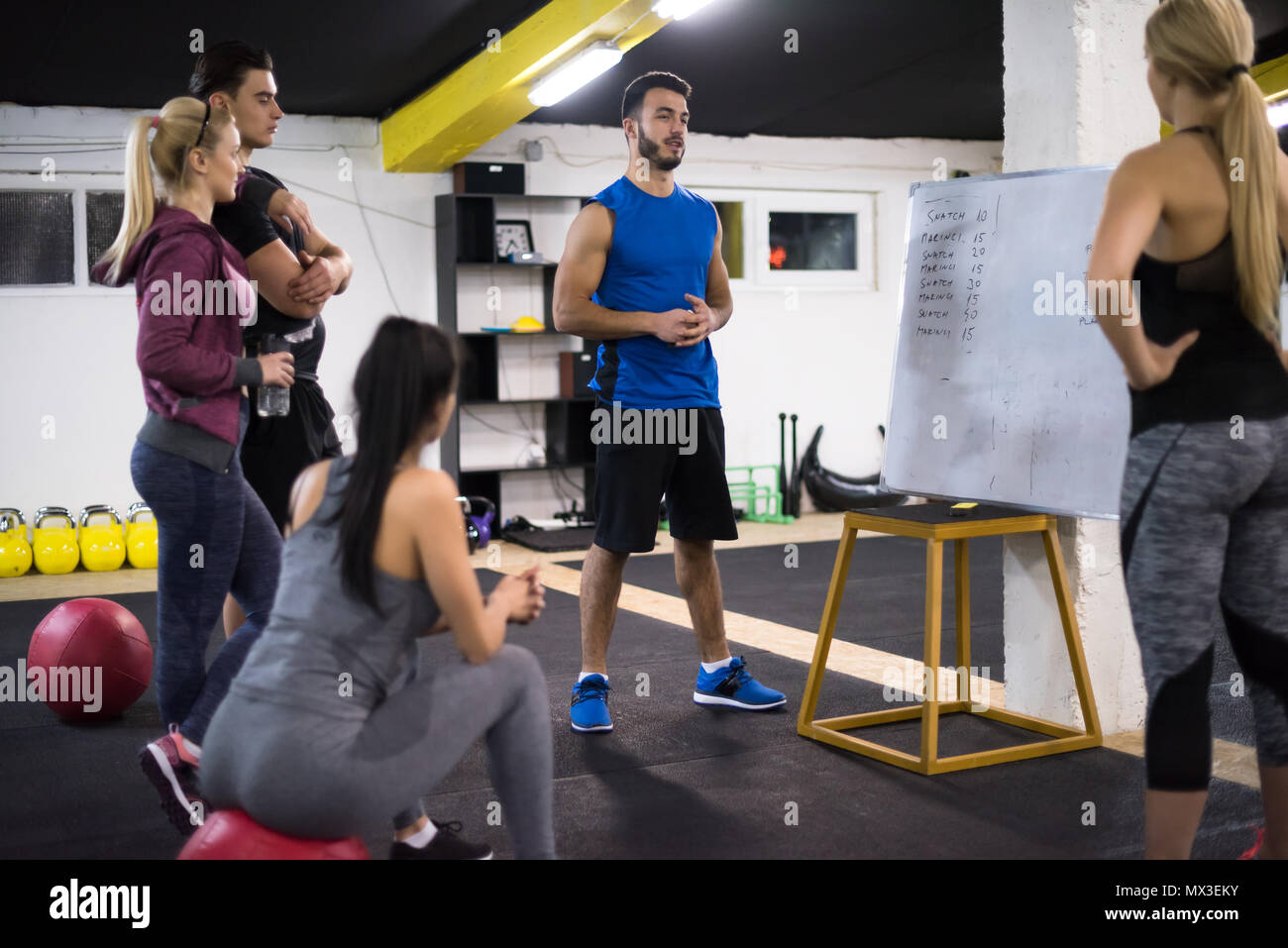 Training course.group of young athletes getting instructions from ...