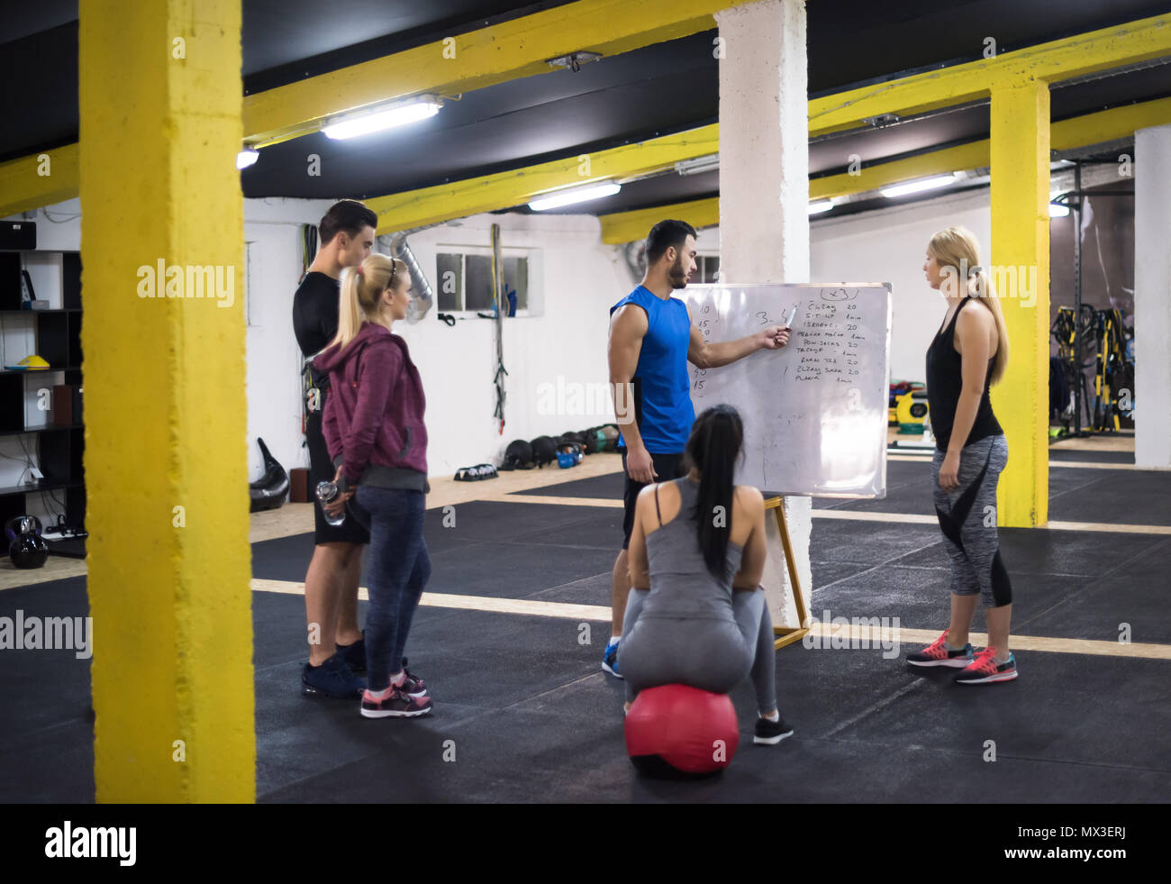 Training course.group of young athletes getting instructions from ...