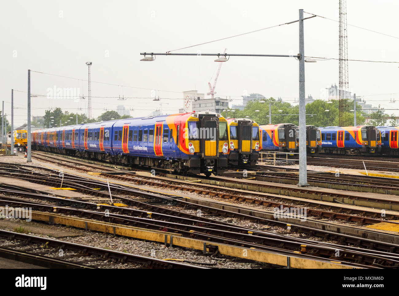 South Western Railway trains in blue, red and yellow livery parked in ...