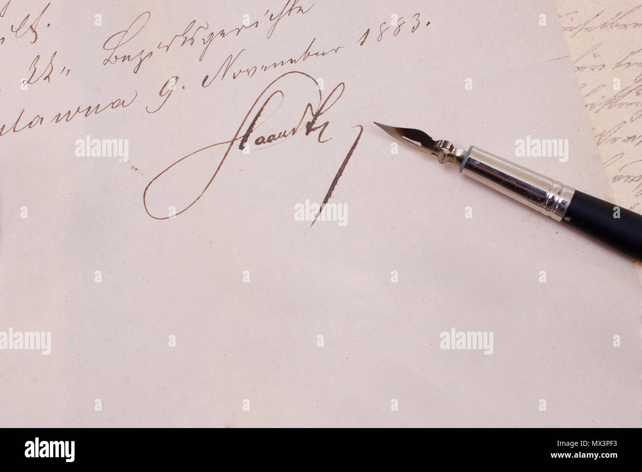 vintage background with retro ink pen on old aged handwriteln letter ...