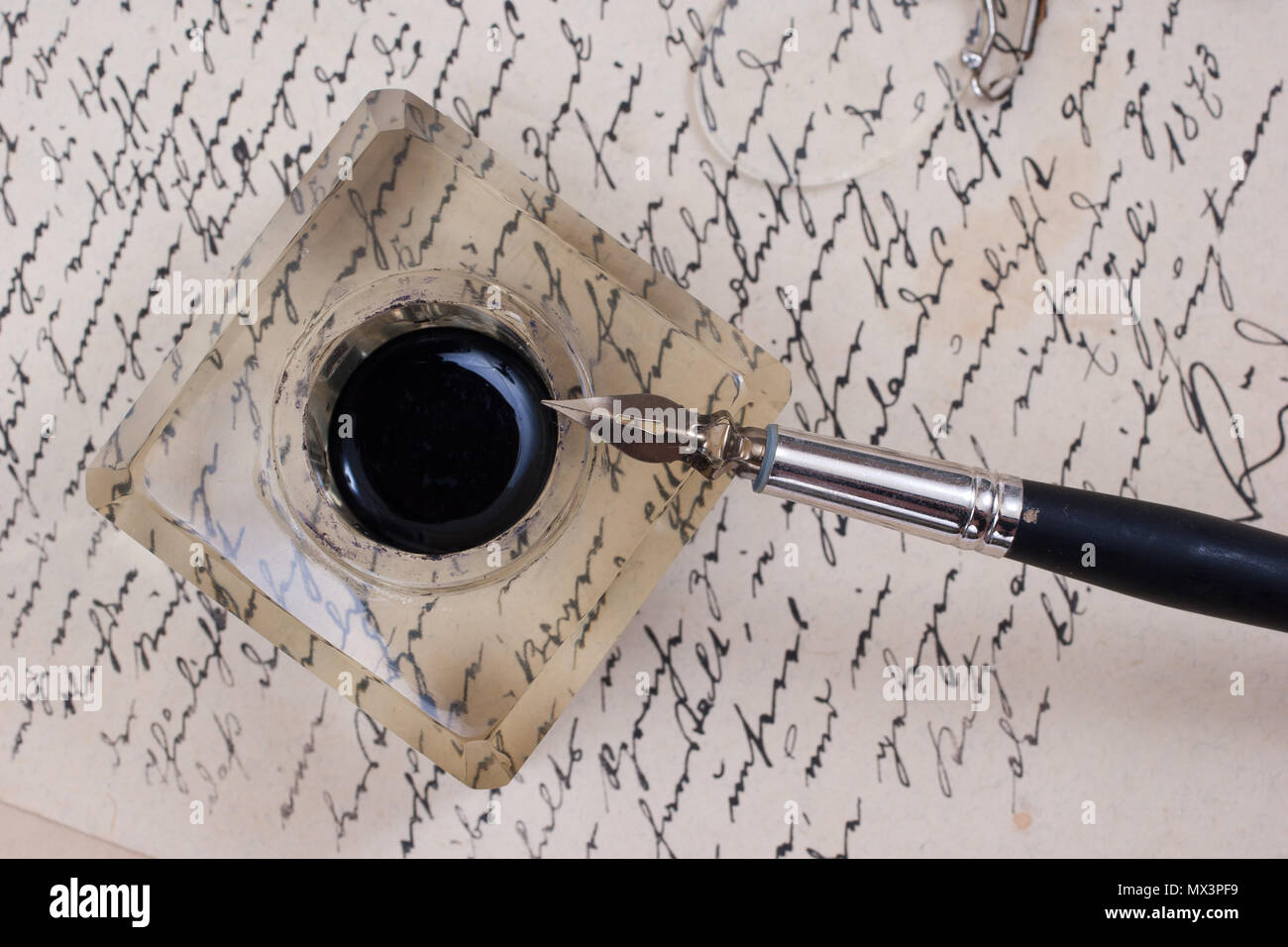 vintage background with retro ink pen on old aged handwriteln letter ...