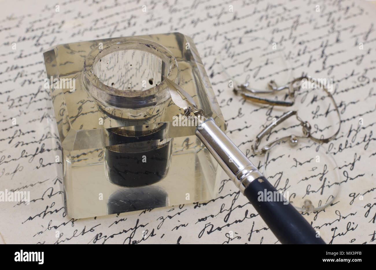 vintage background with retro ink pen on old aged handwriteln letter ...