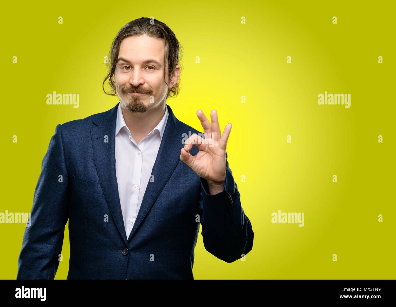 Handsome young man doing ok sign gesture with both hands expressing ...