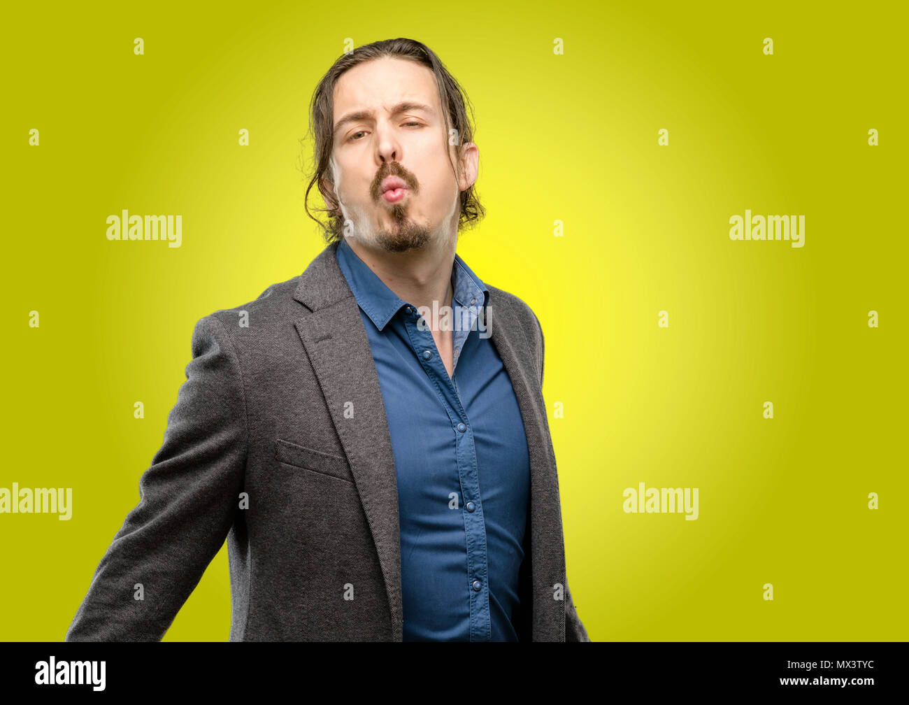 Handsome young man expressing love, blows kiss at camera, flirting ...