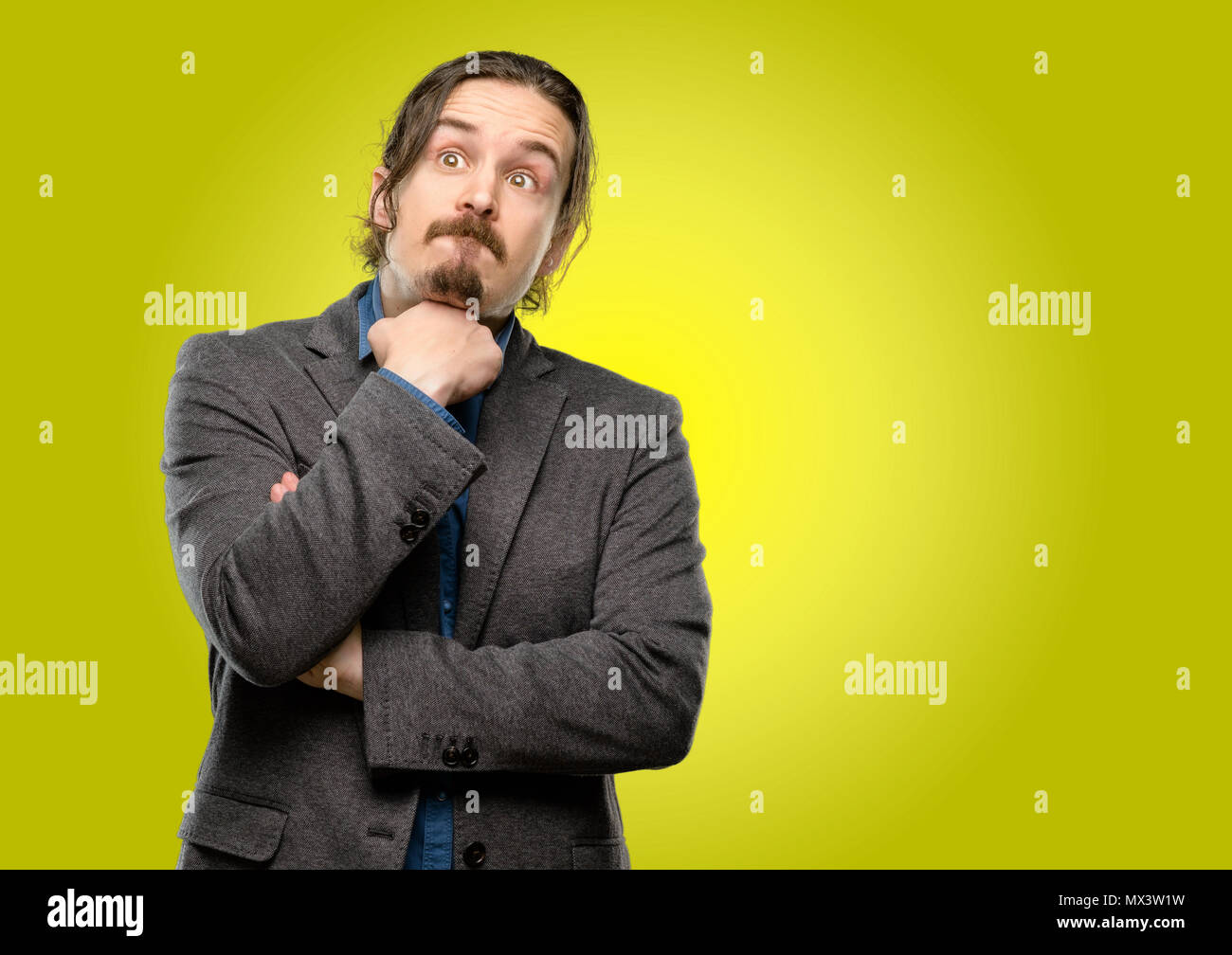 Handsome young man doubt expression, confuse and wonder concept ...