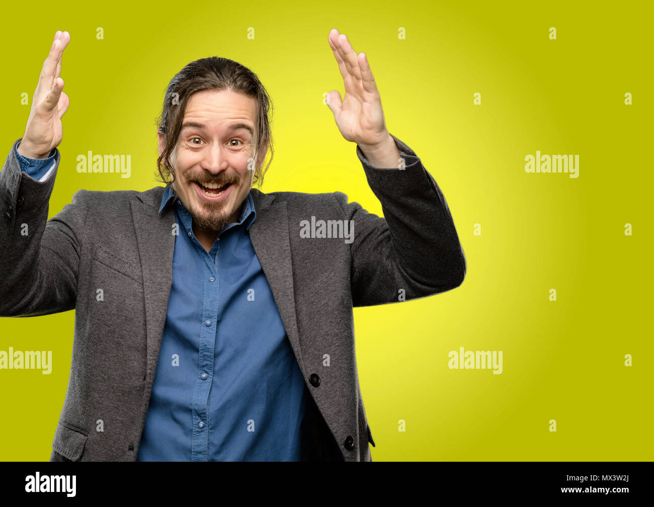 Handsome young man happy and surprised cheering expressing wow gesture ...