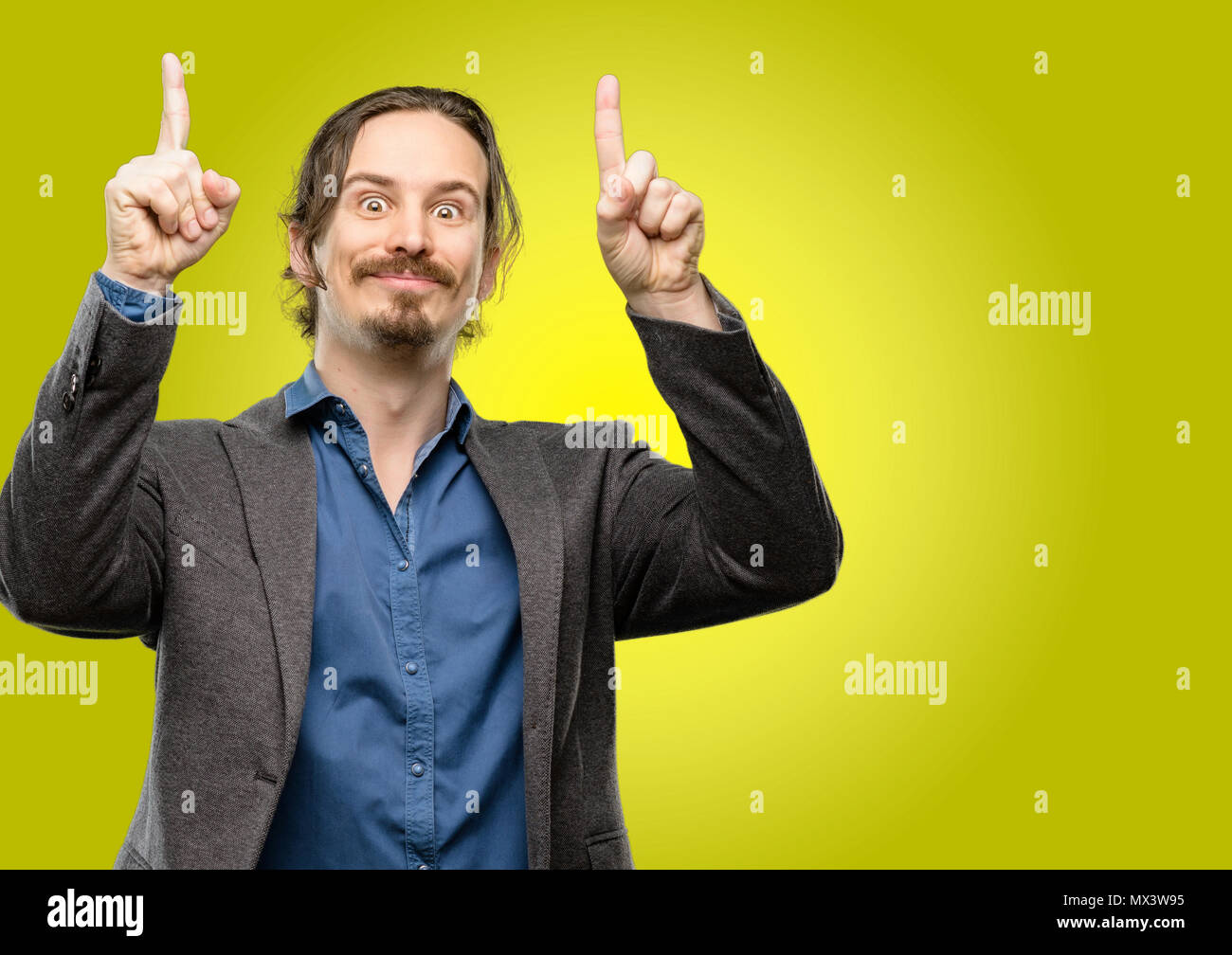 Handsome young man raising his finger, is the number one Stock Photo ...