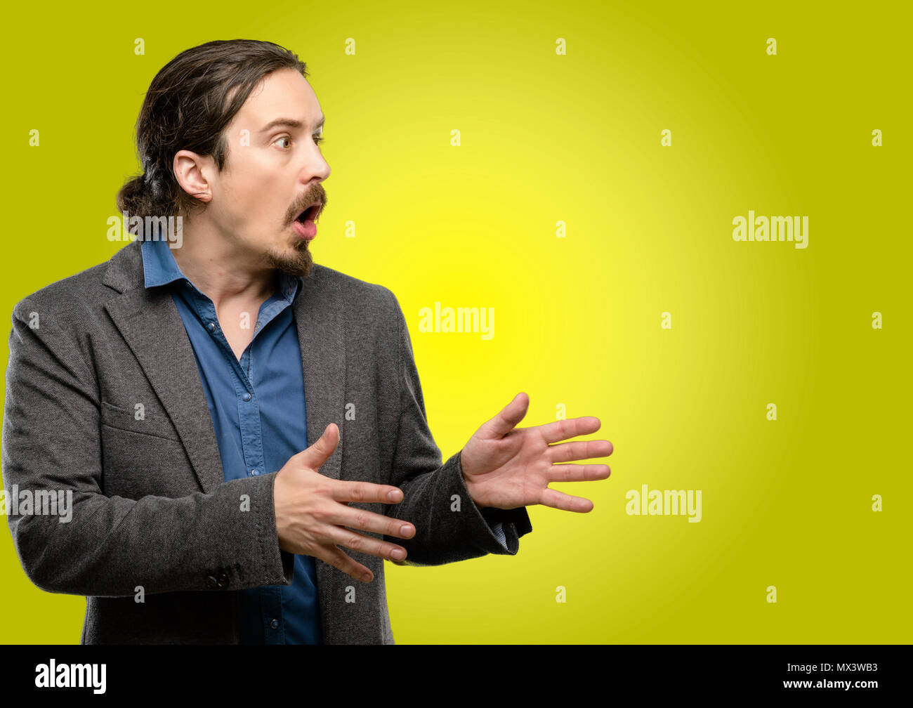 Handsome young man stressful keeping hands on head, terrified in panic ...