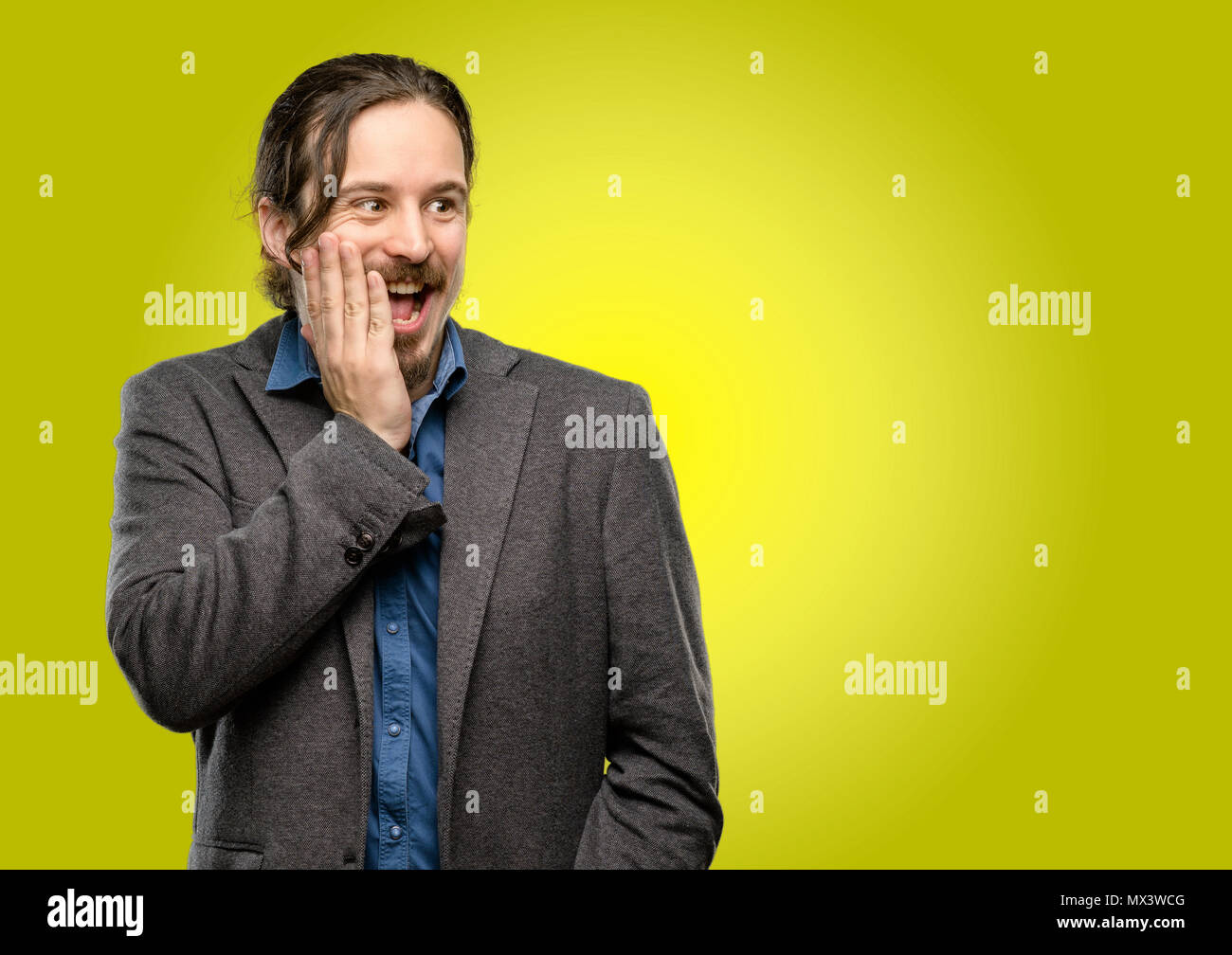 Handsome young man so happy and confident showing a big smile surprised ...