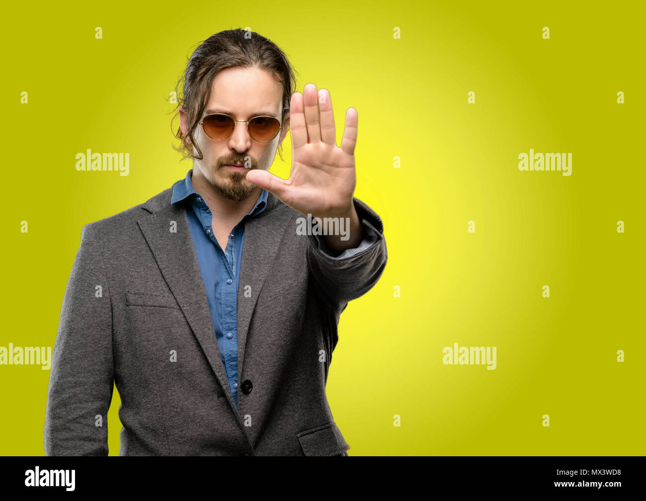 Handsome young man annoyed with bad attitude making stop sign with hand ...