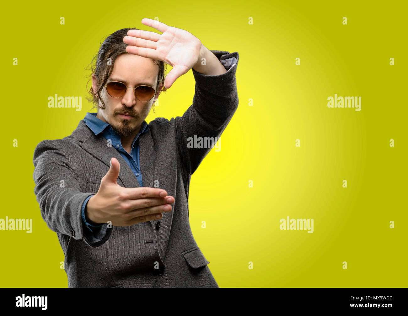 Handsome young man annoyed with bad attitude making stop sign with hand ...