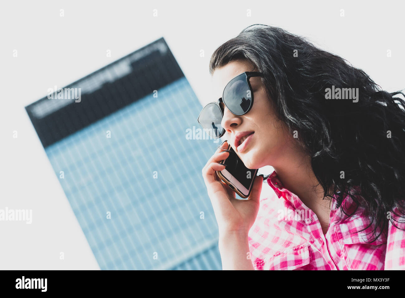 Close-up of Young Woman talking to someone on her mobile phone while ...