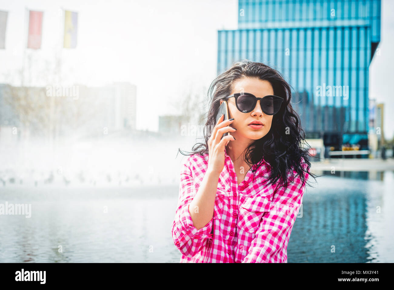 Attractive spontaneous woman talking on the phone. Authenticity and ...