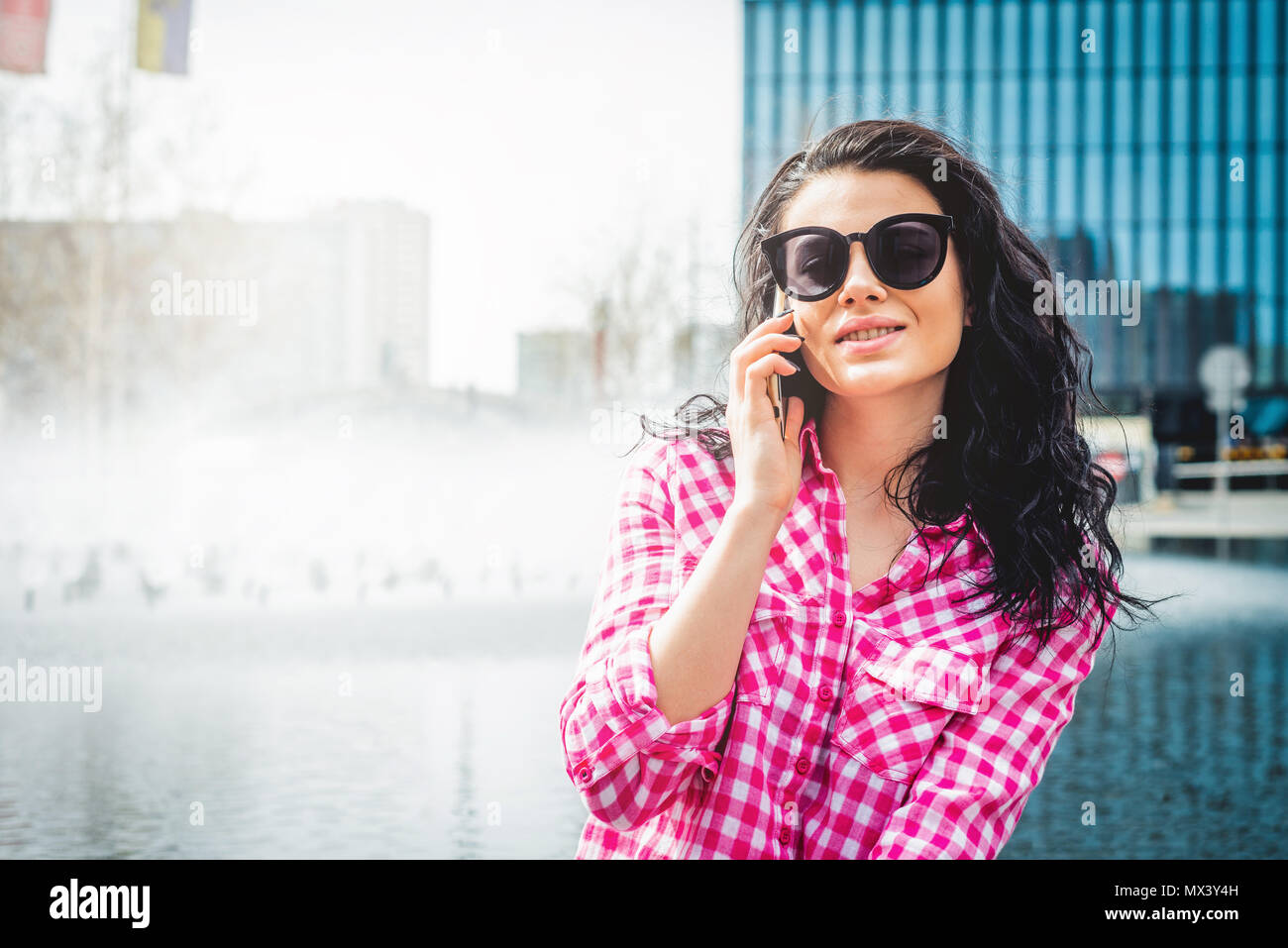 Attractive spontaneous woman talking on the phone. Authenticity and ...