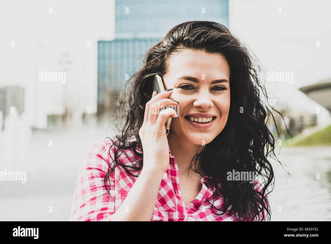Attractive spontaneous woman talking on the phone. Authenticity and ...