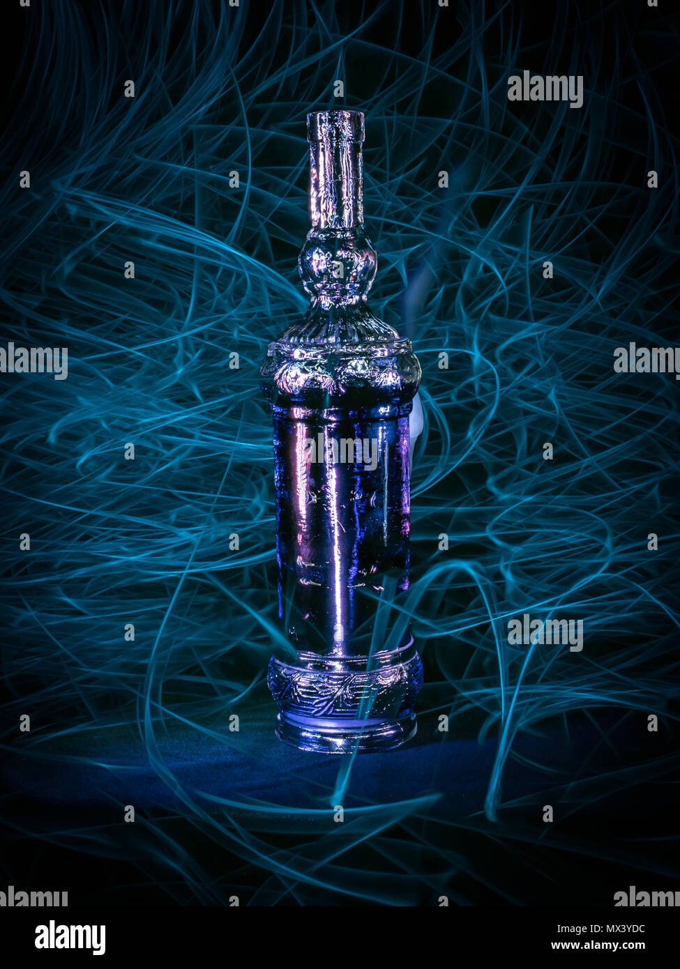 Decorative bottle with purple content illuminated with lightpainting ...