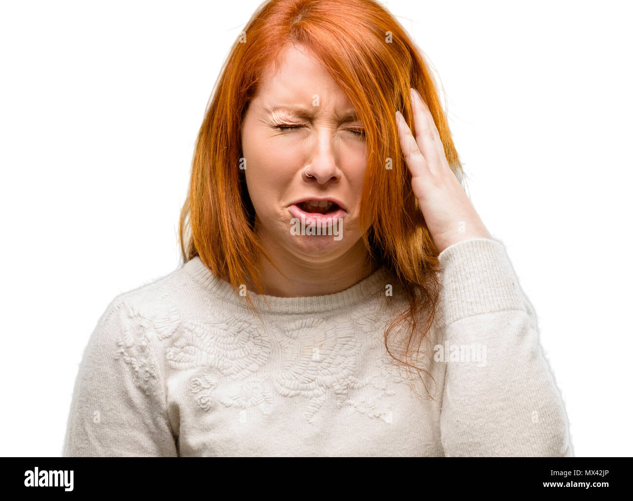 Beautiful young redhead woman crying depressed full of sadness ...