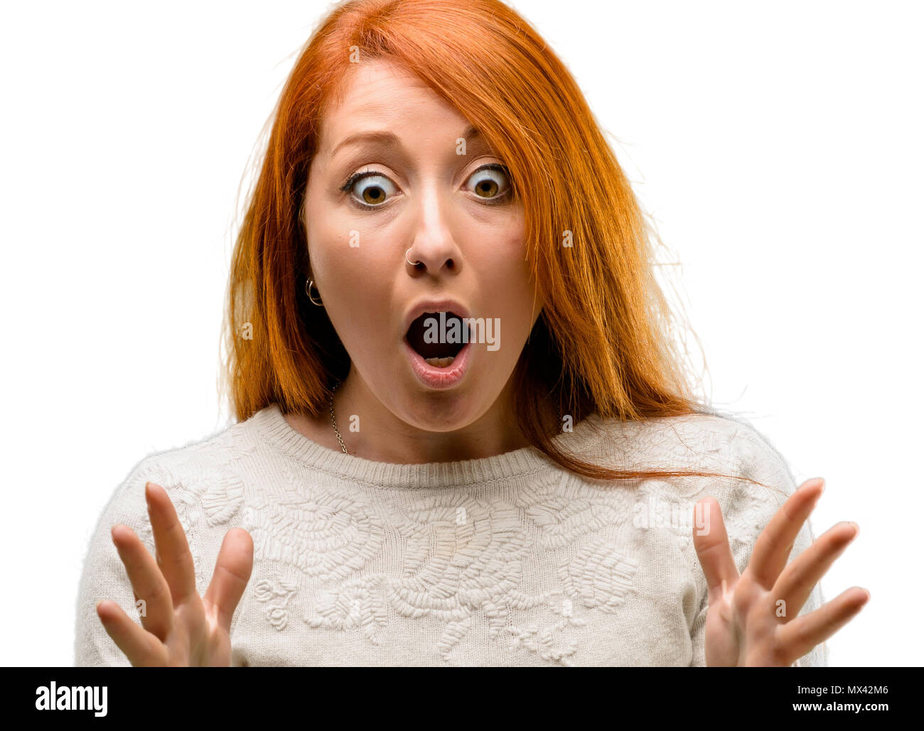 Beautiful young redhead woman stressful keeping hands on head ...