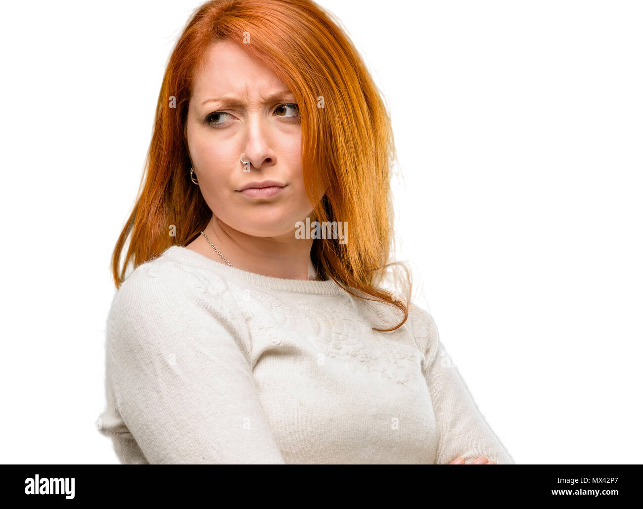 Beautiful young redhead woman irritated and angry expressing negative ...